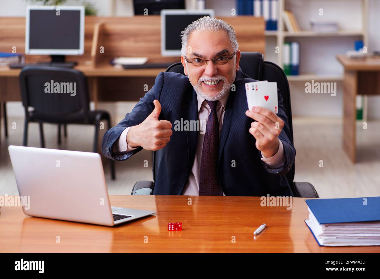 Old businessman employee playing cards at workplace Stock Photo - Alamy