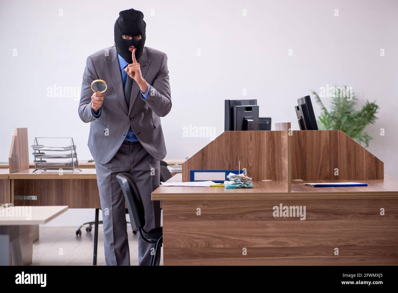 Young employee in industrial espionage concept Stock Photo - Alamy