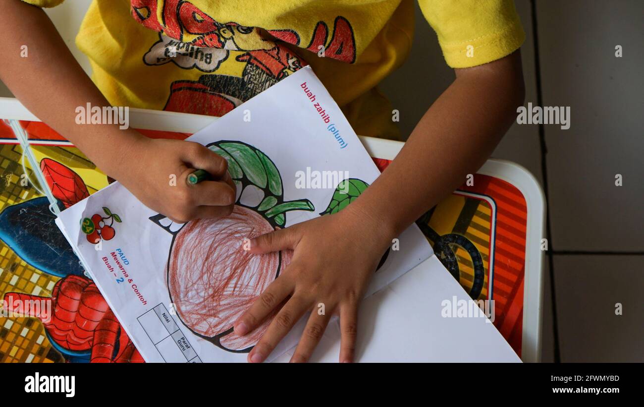 Close up of children learning to color pictures Stock Photo - Alamy