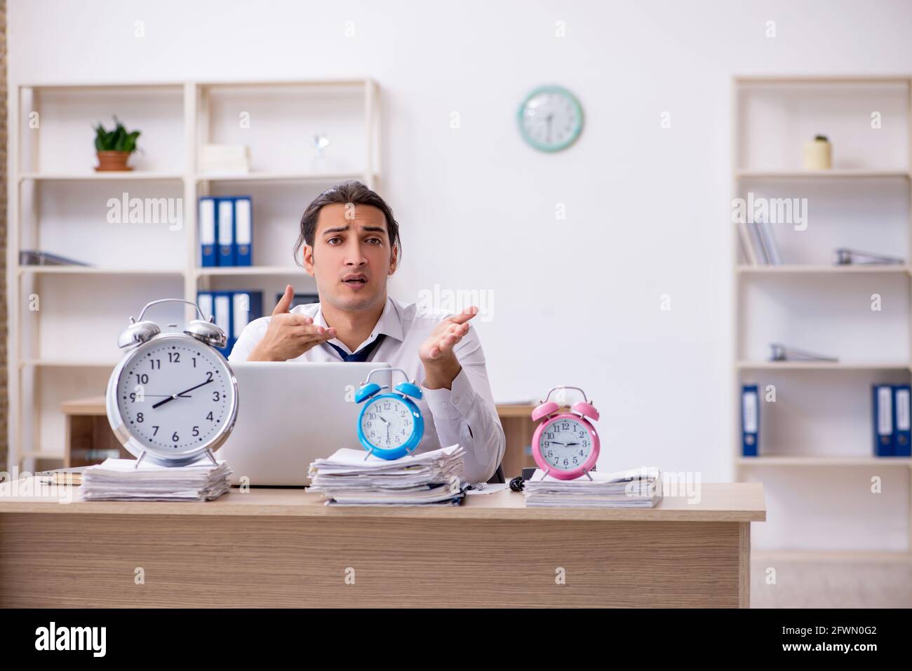 Young employee afraid of missing deadline at workplace Stock Photo - Alamy