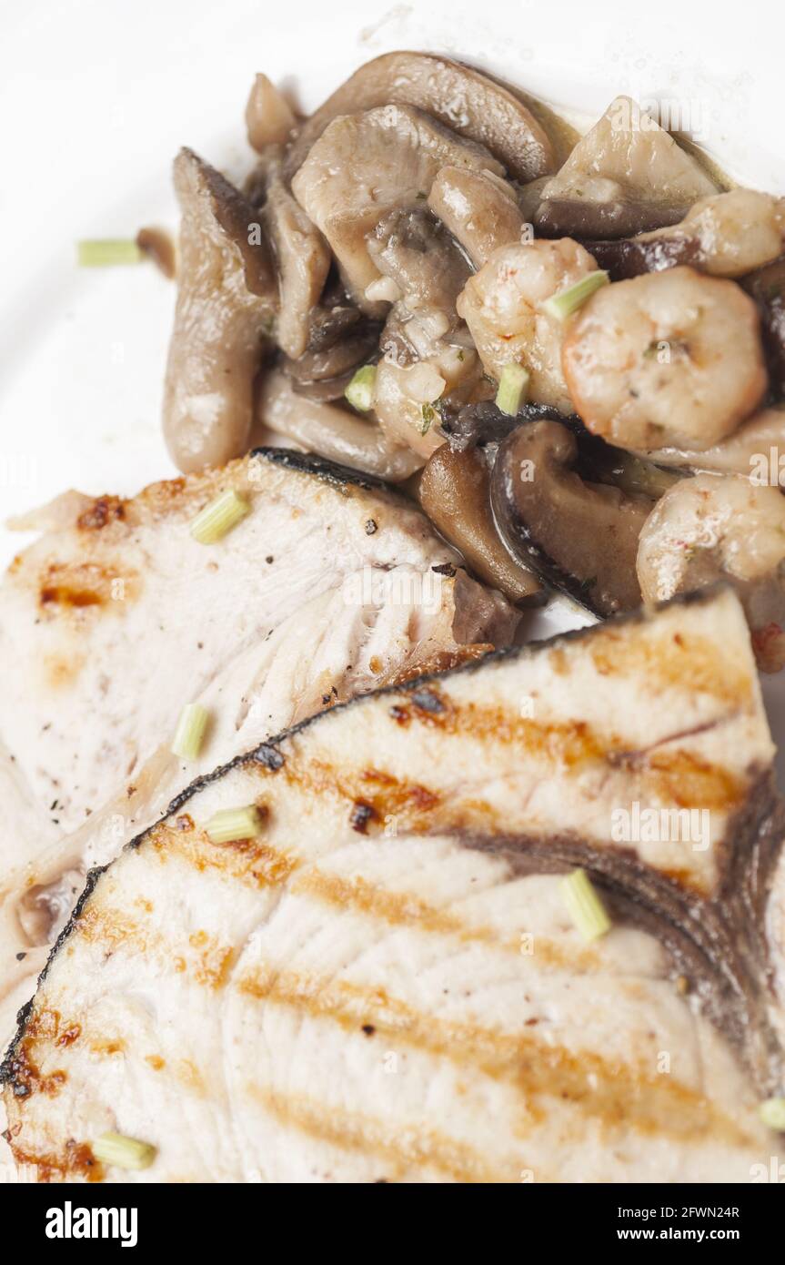 Close-up shot of an emperor Fish fillets grilled with mushrooms and ...