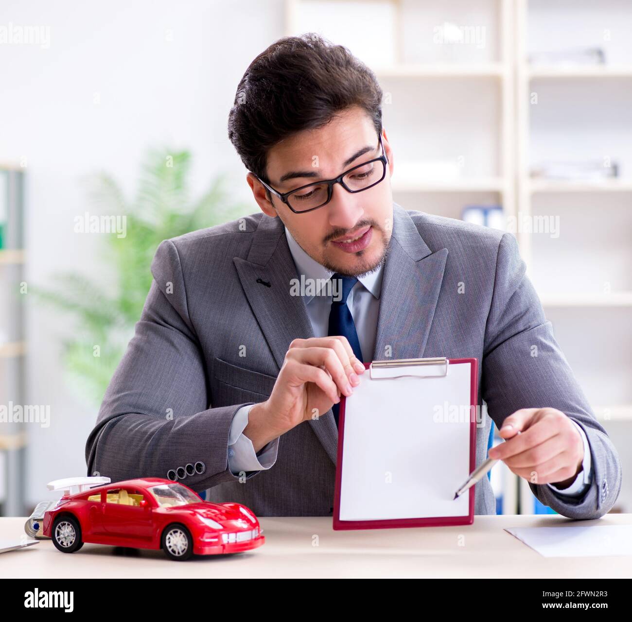 The agent offering car motor insurance Stock Photo - Alamy