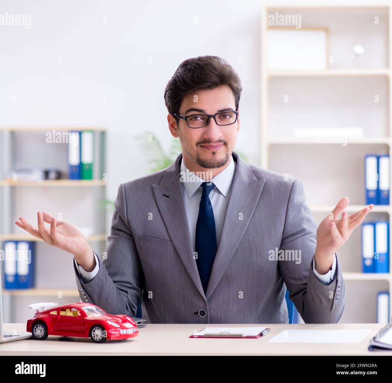 The agent offering car motor insurance Stock Photo - Alamy