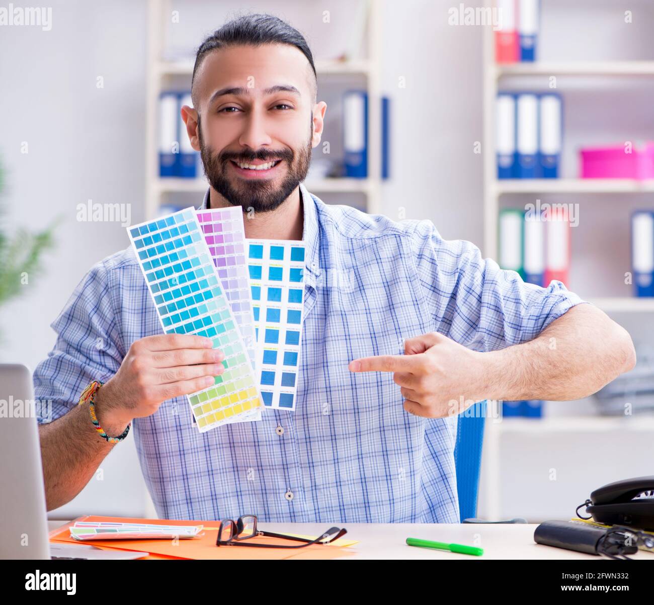 The young designer working in his studio on new project Stock Photo - Alamy