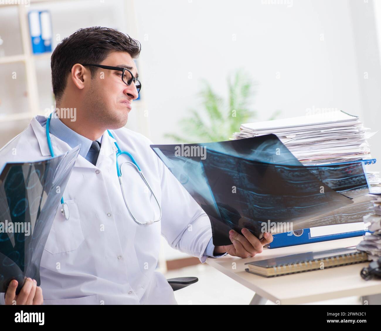The tired radiologist with x-ray image in hospital Stock Photo - Alamy