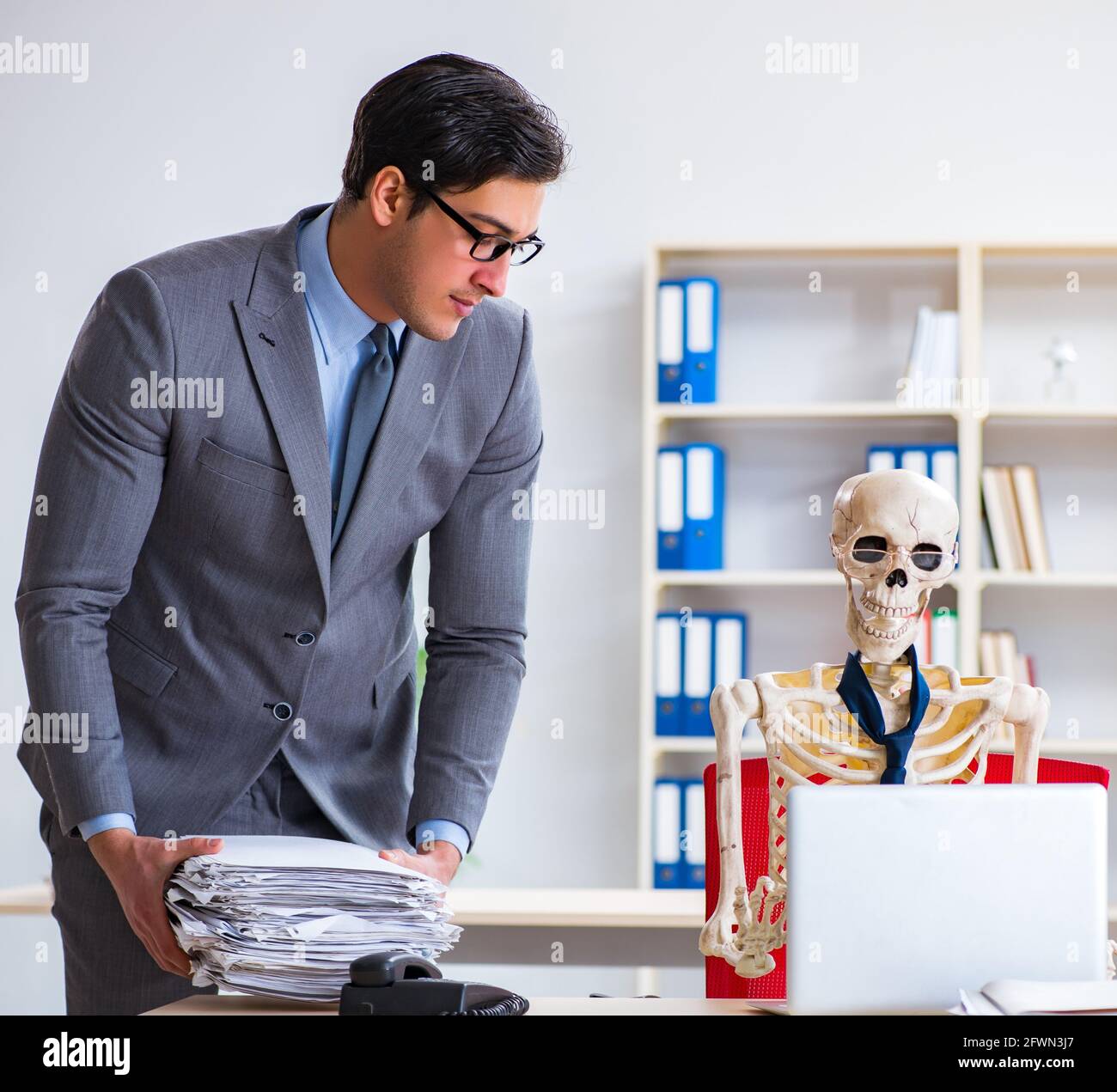 The angry boss yelling at his skeleton employee Stock Photo - Alamy