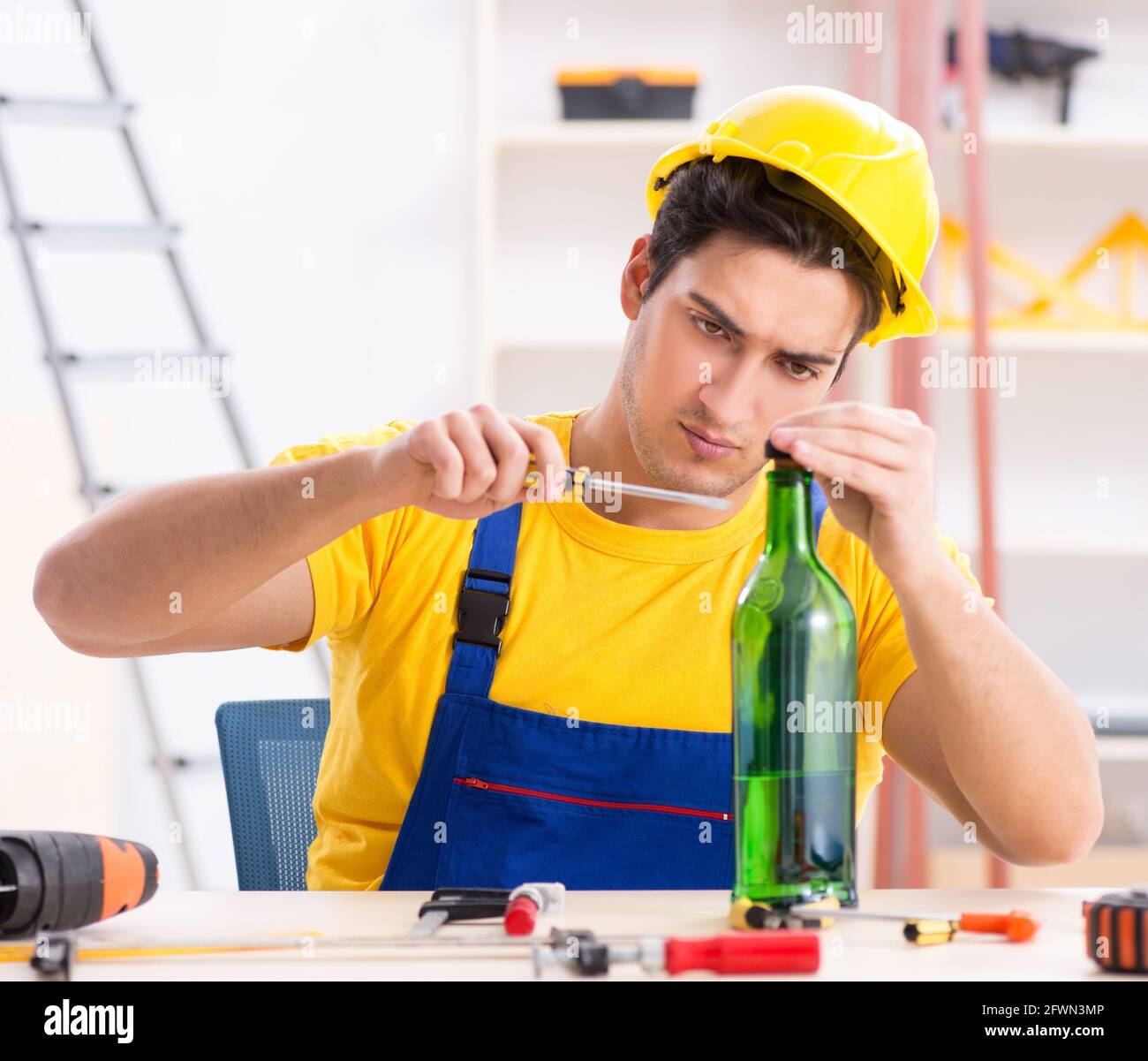 The drunk engineer working in the workshop Stock Photo - Alamy