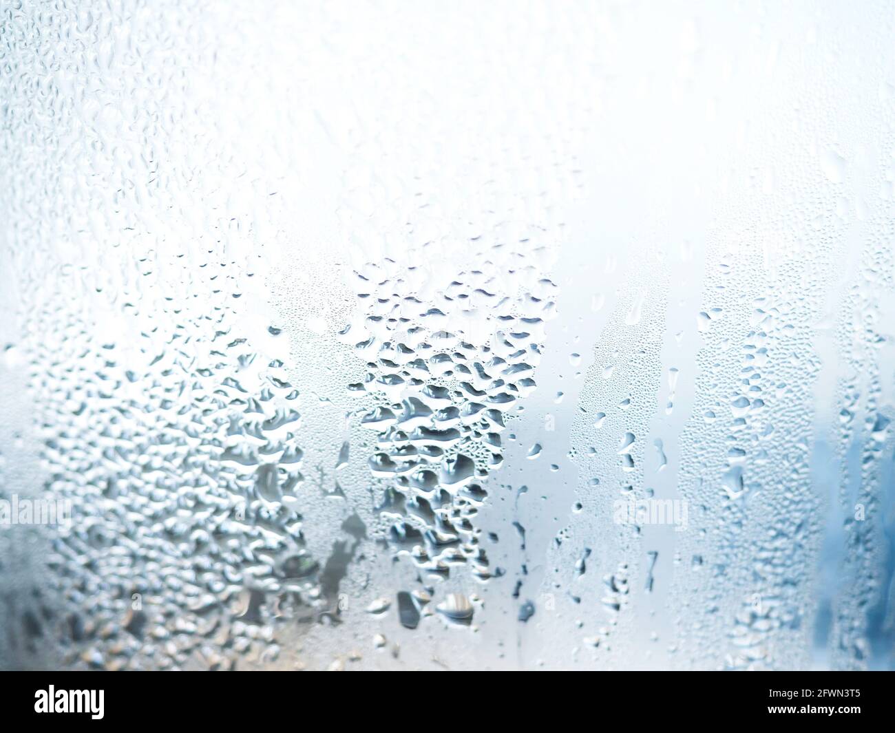 Close-up nature water drops texture on glass with blurred blue ...