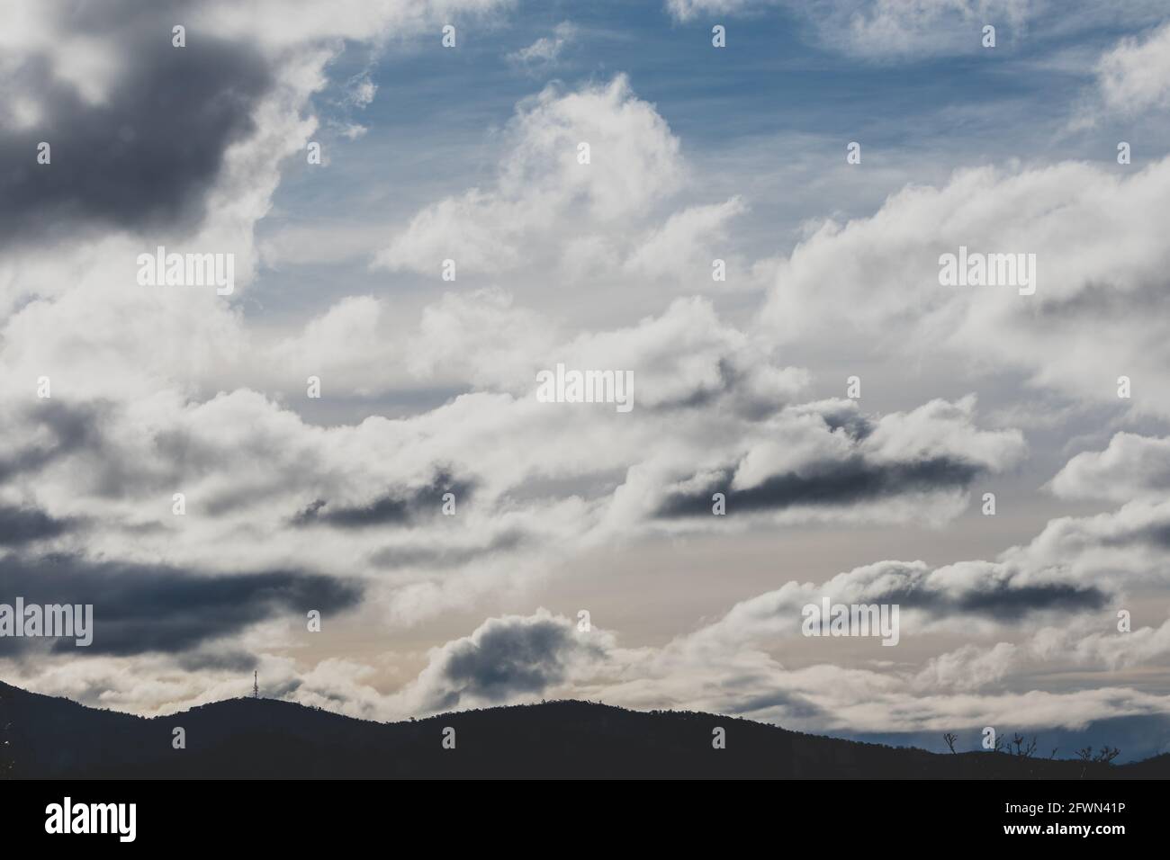 beautiful sky with clouds rolling over the mountains in Tasmania ...