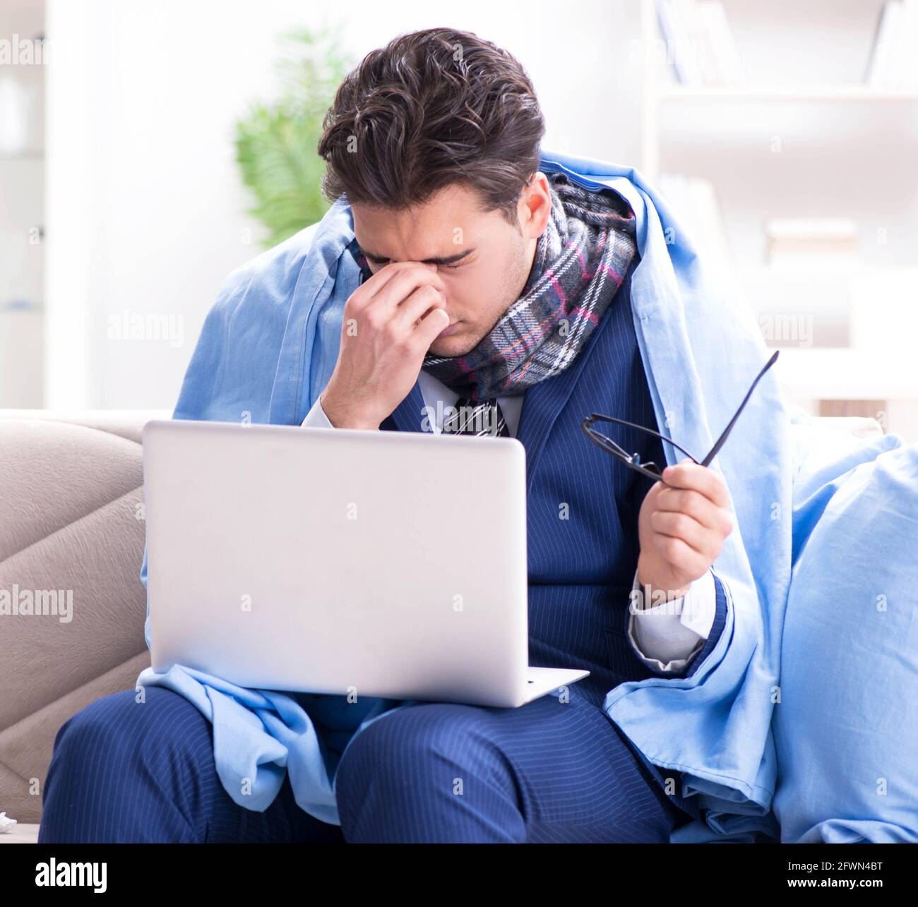 The sick businessman working from home due to flu sickness Stock Photo ...