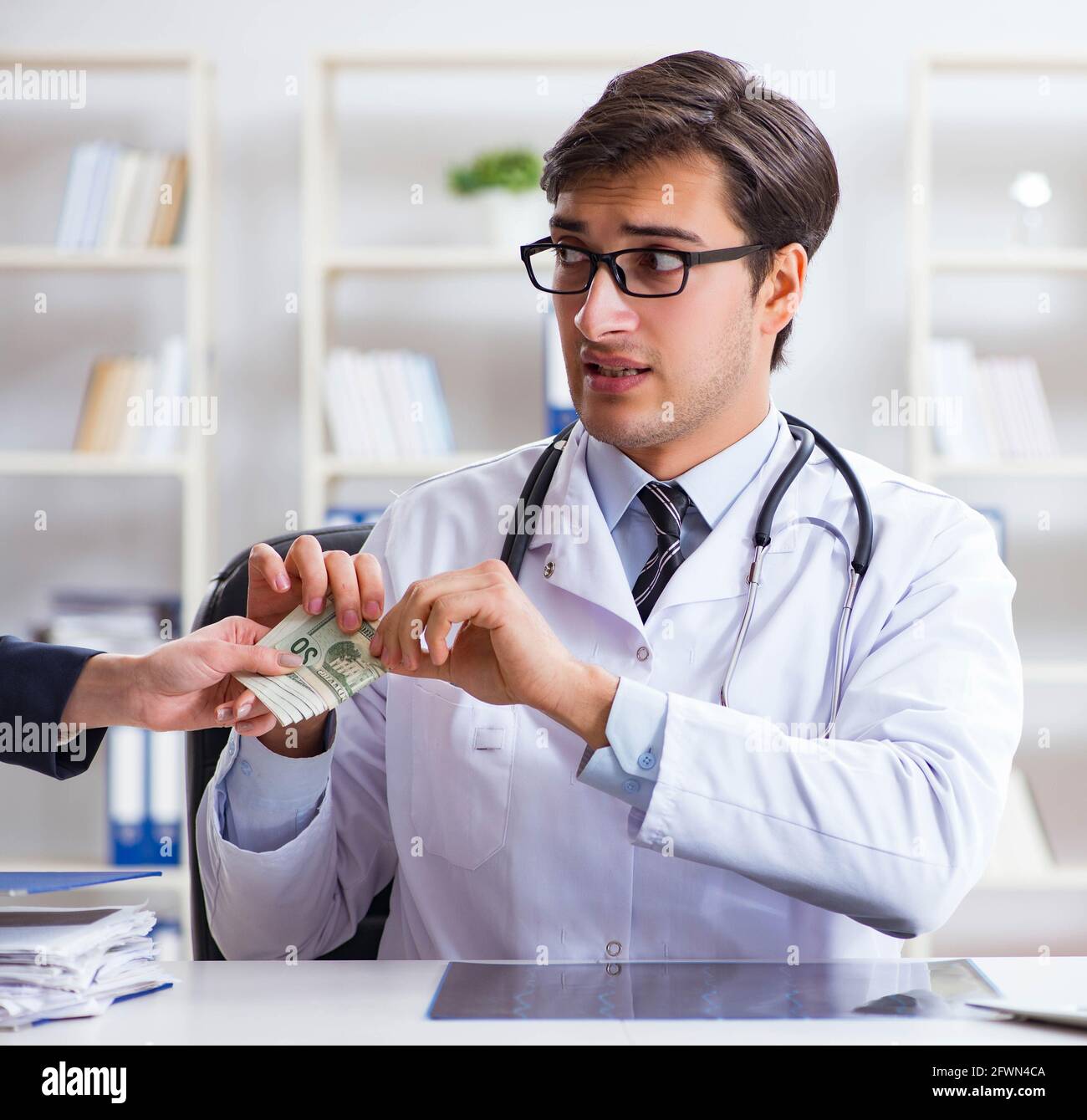 The doctor in corruption concept with being offered bribe Stock Photo ...