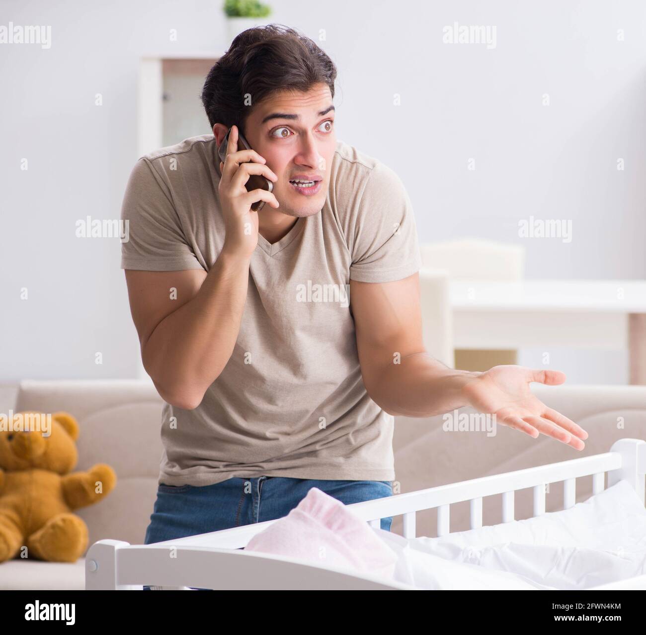The young father dad frustrated at crying baby Stock Photo - Alamy