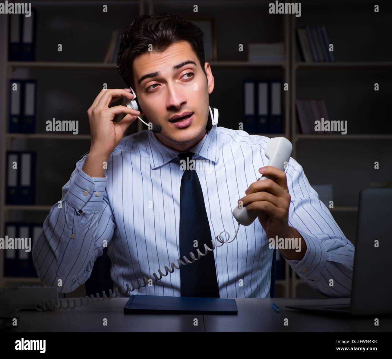 The call center operator talking to customer during night shift Stock ...