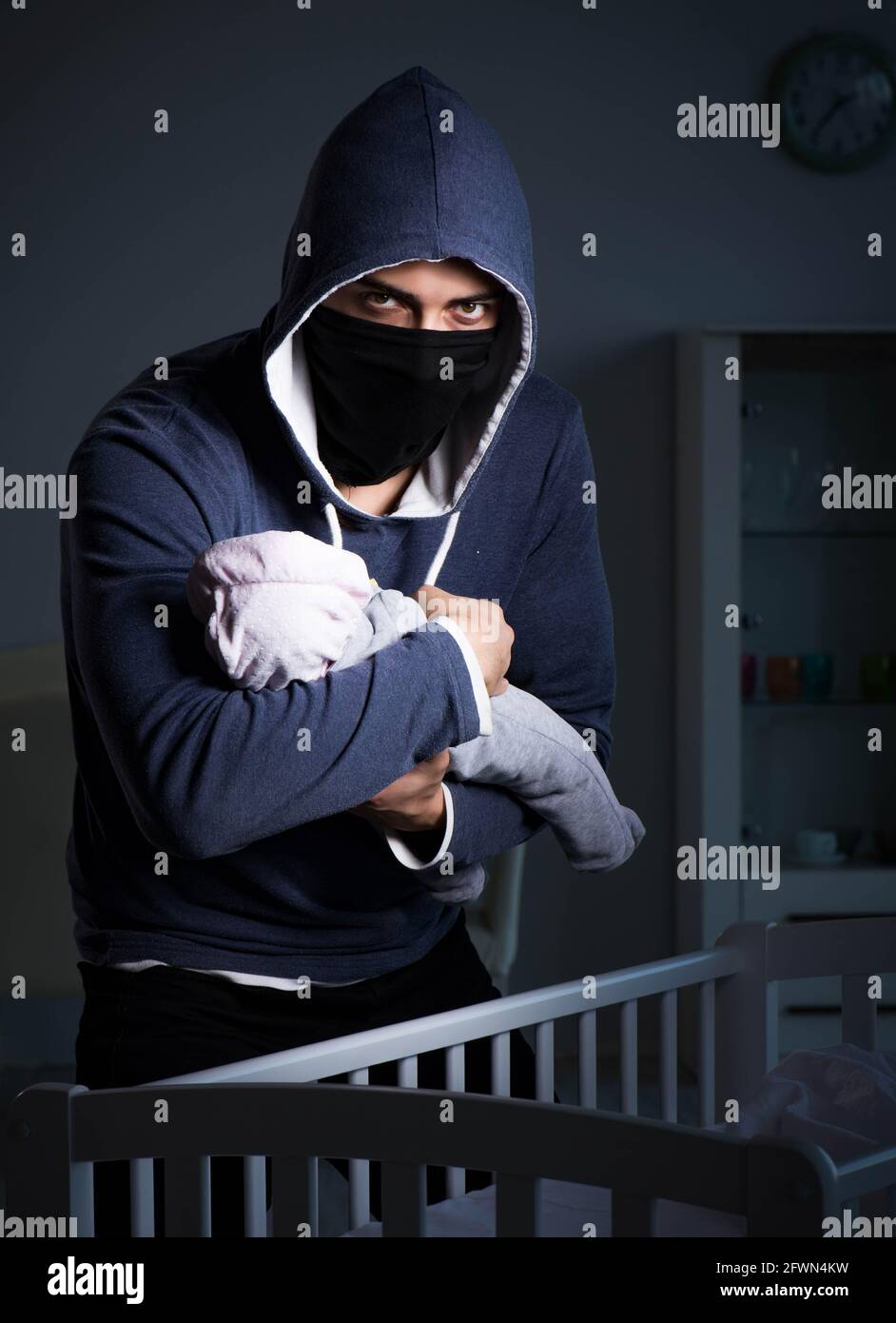 The criminal stealing baby in human child traficking concept Stock ...