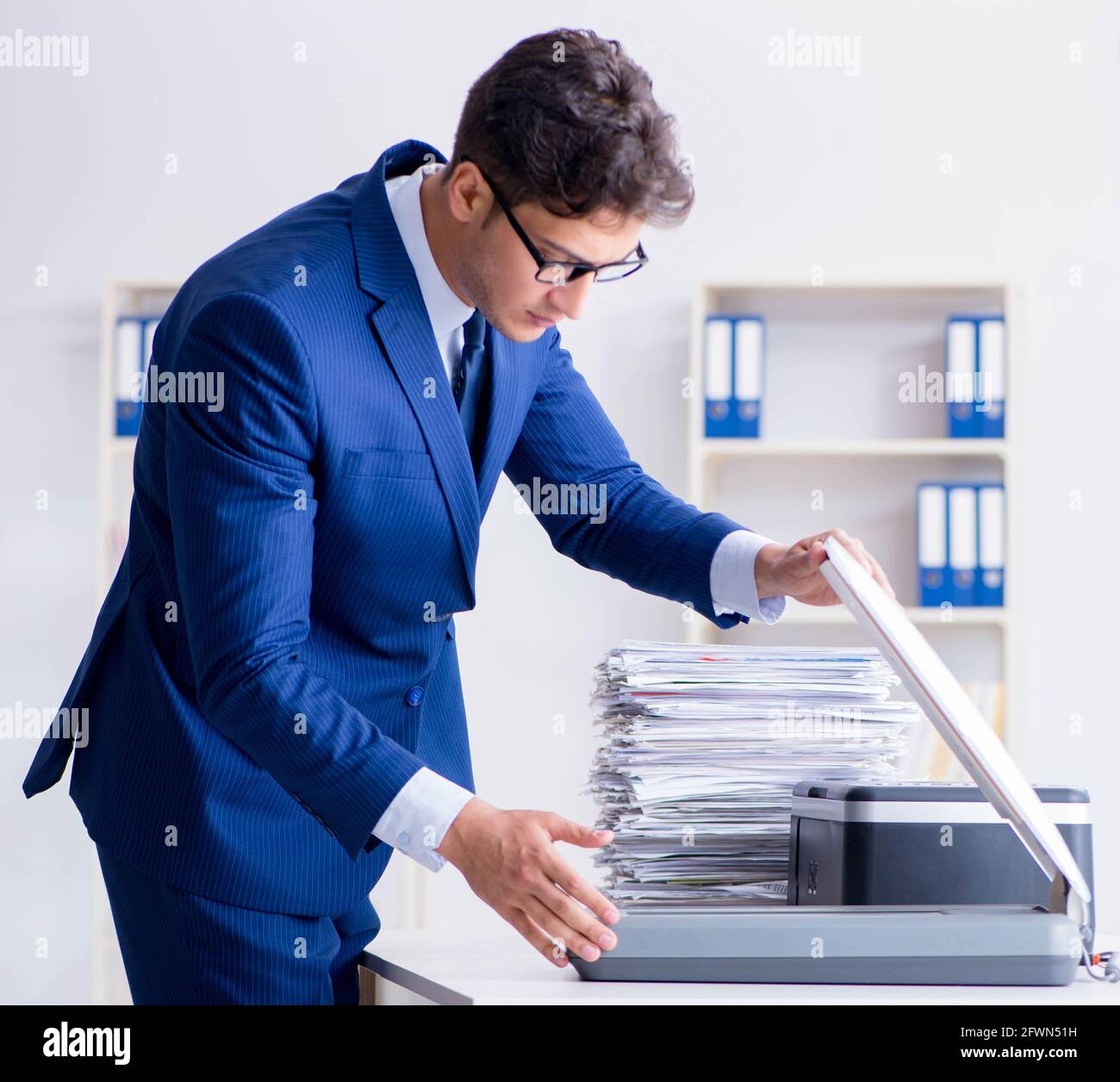 The businessman making copies in copying machine Stock Photo - Alamy