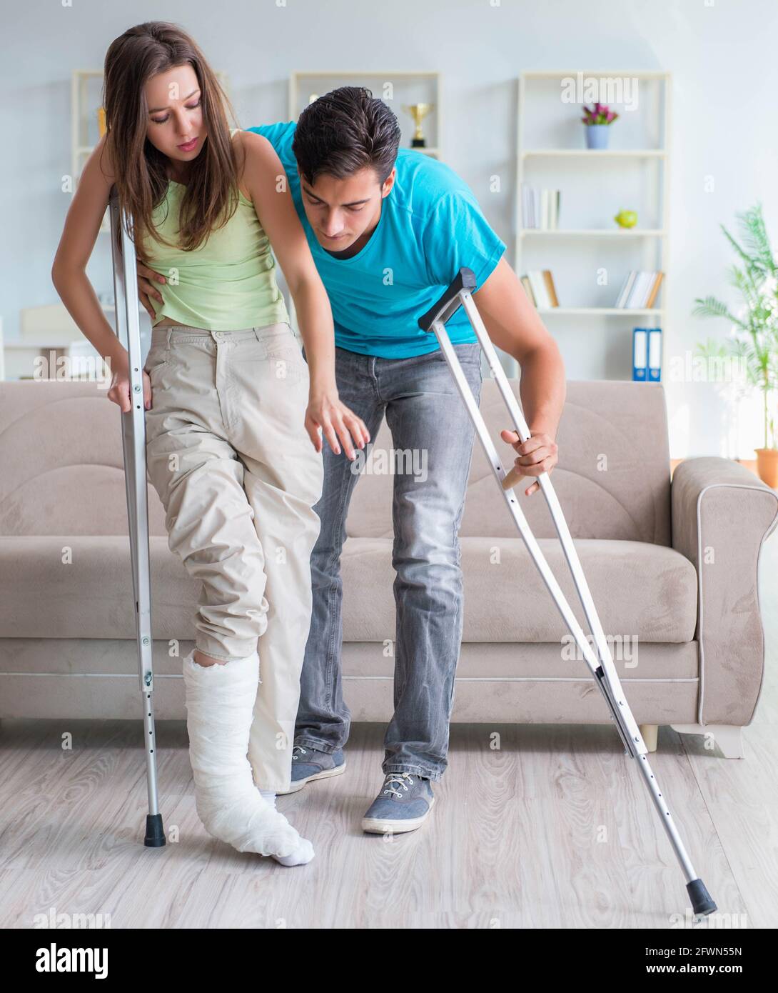 The husband man supporting injured wife Stock Photo - Alamy