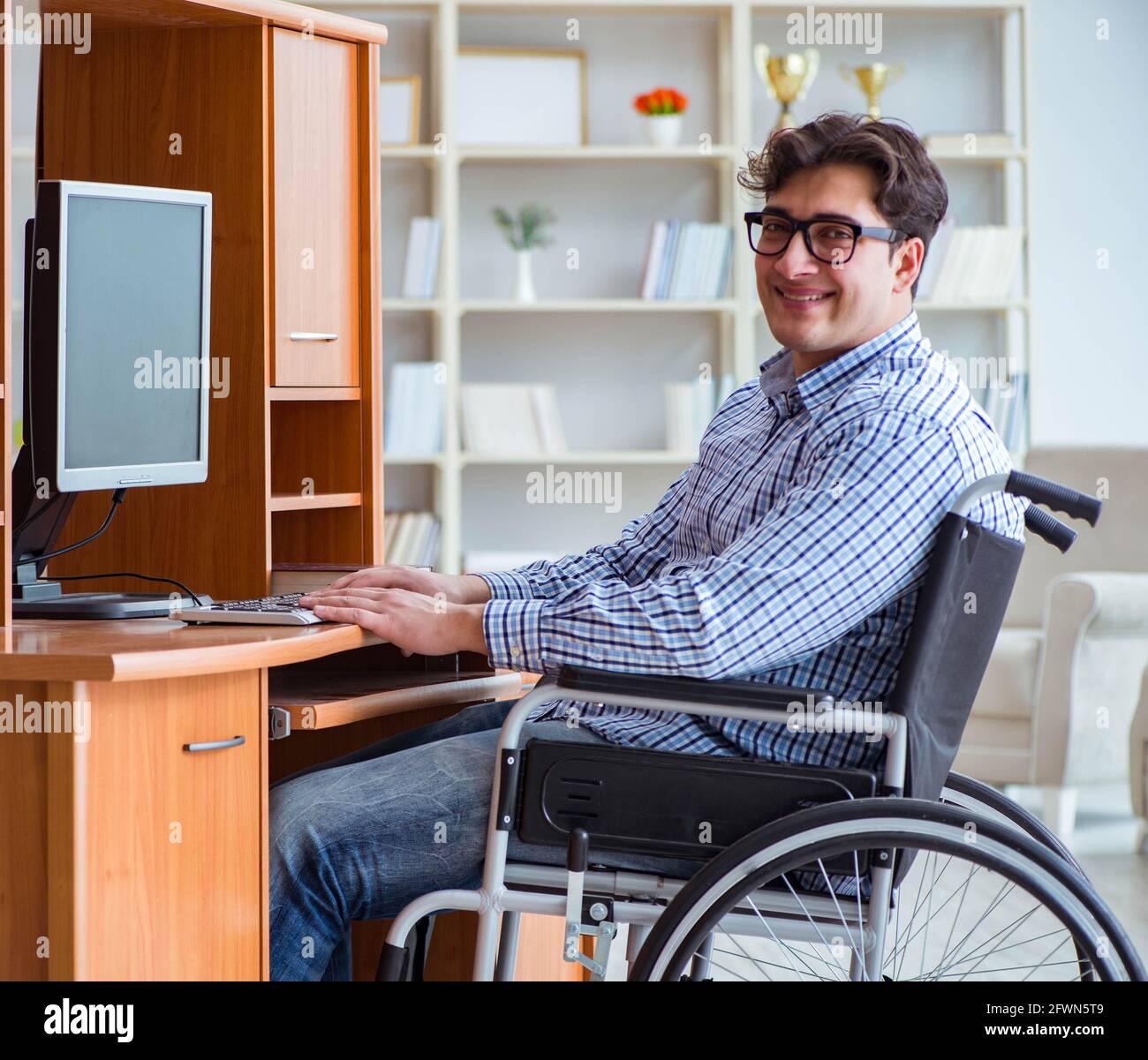 The disabled student studying at home on wheelchair Stock Photo - Alamy