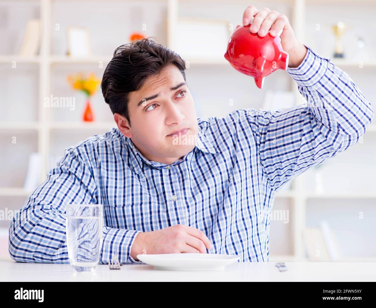 Man running out of money in restaurant and using savings from piggy ...