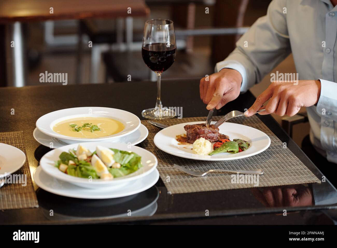 Young man eating in fancy restaurant hi-res stock photography and ...