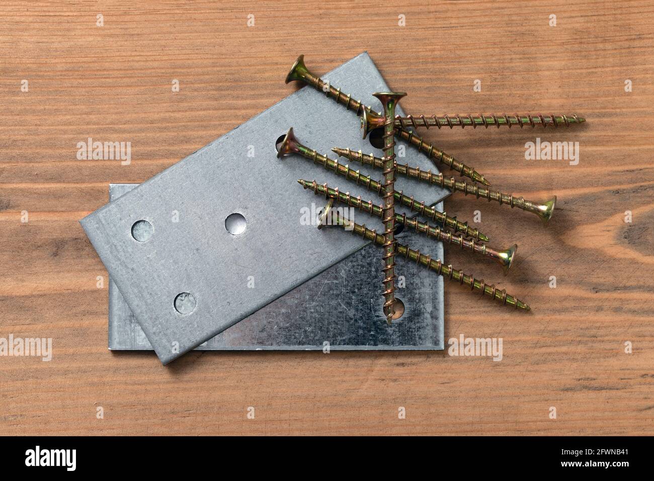Close-up of iron steel gray plates with three holes with several ...