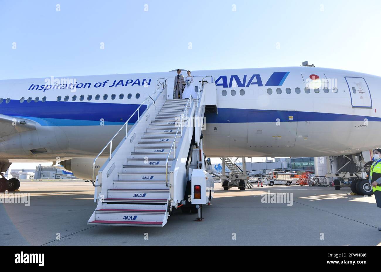 Mr. Toru and Mrs. Mami MURAKAMI exiting the aircraft after their ...
