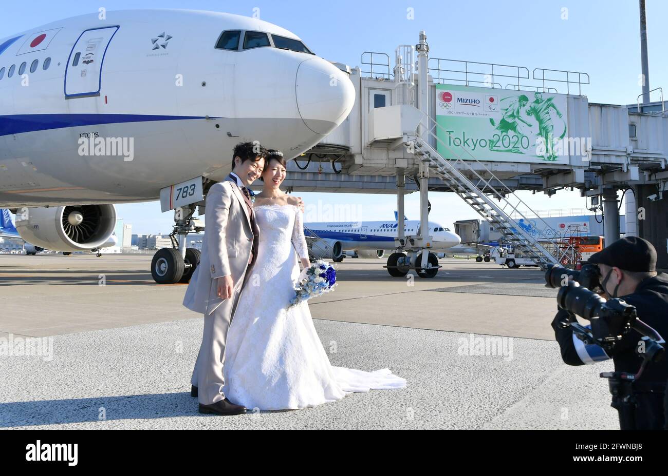 Mr. Toru and Mrs. Mami MURAKAMI pose for a photo with the aircraft in the background after their ...