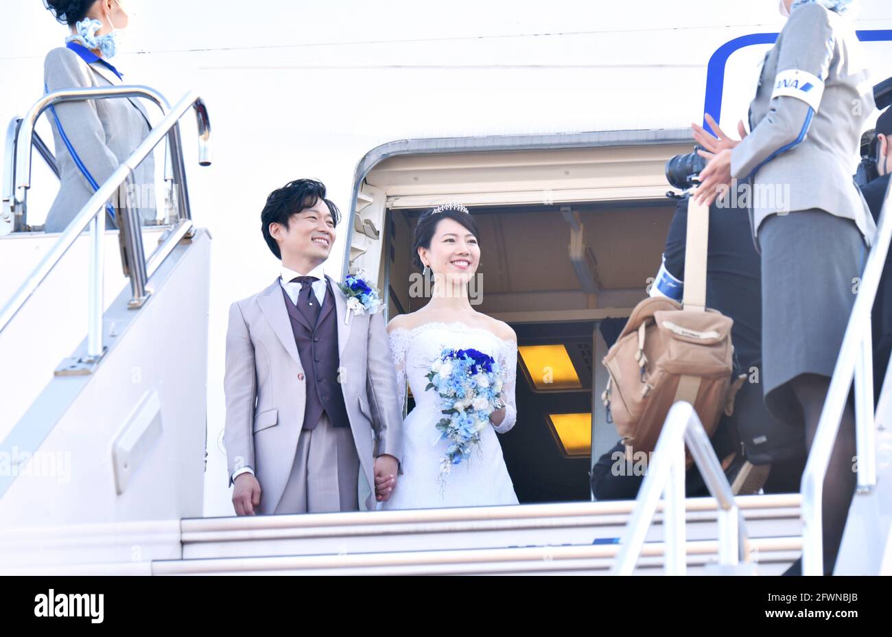 Mr. Toru and Mrs. Mami MURAKAMI exiting the aircraft after their wedding ceremony on board the ...