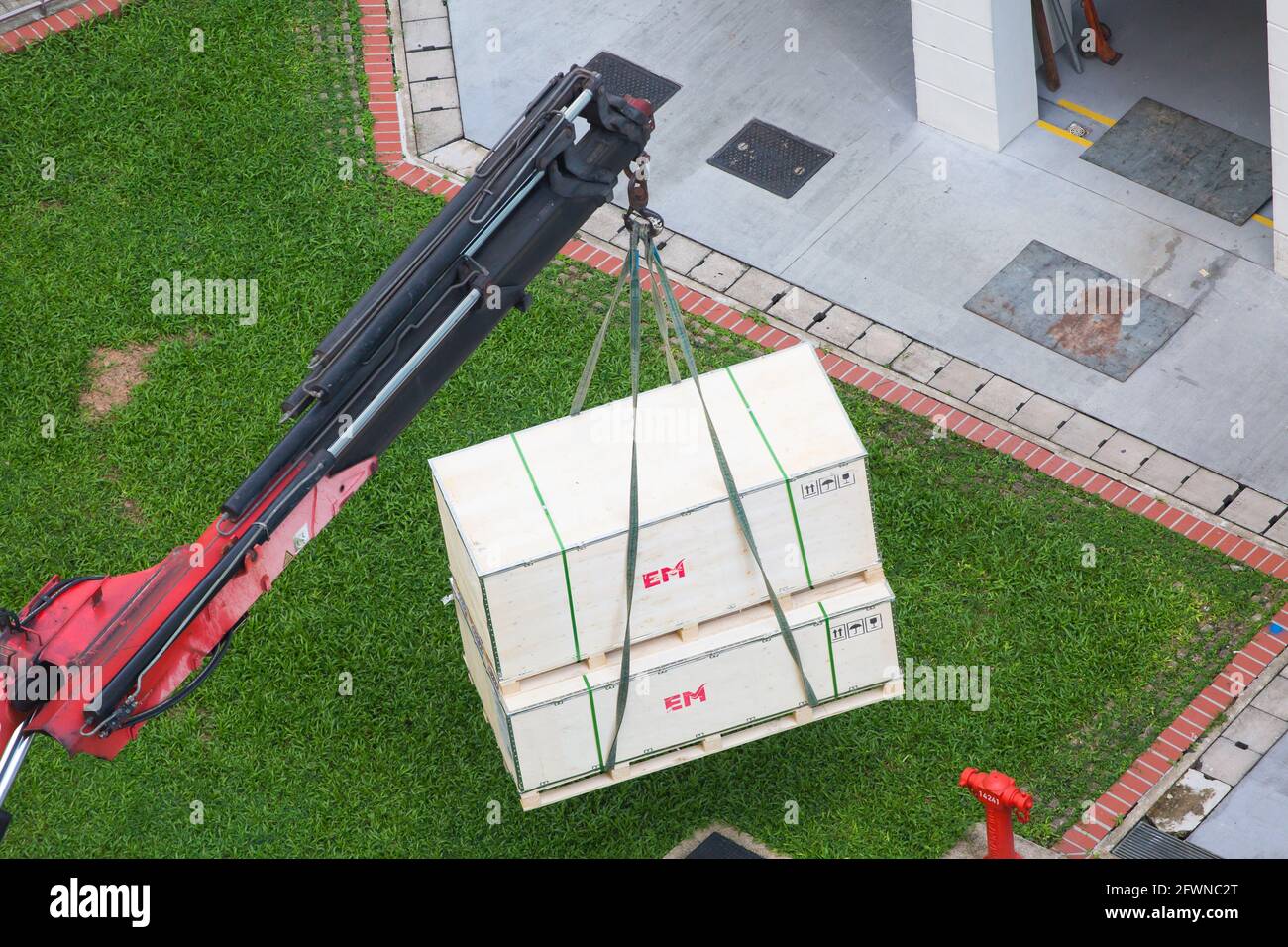 Close up of a hydraulic-powered crane unloading heavy crates Stock ...