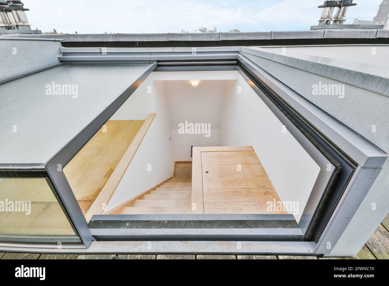 From above of wooden steps with opened window leading to rooftop of ...