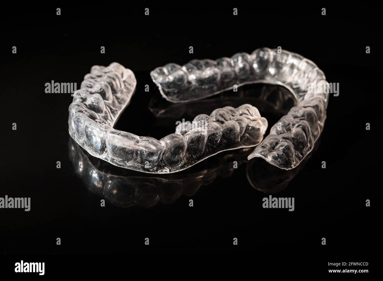 Removable plastic retainers for bite correction on a black background ...
