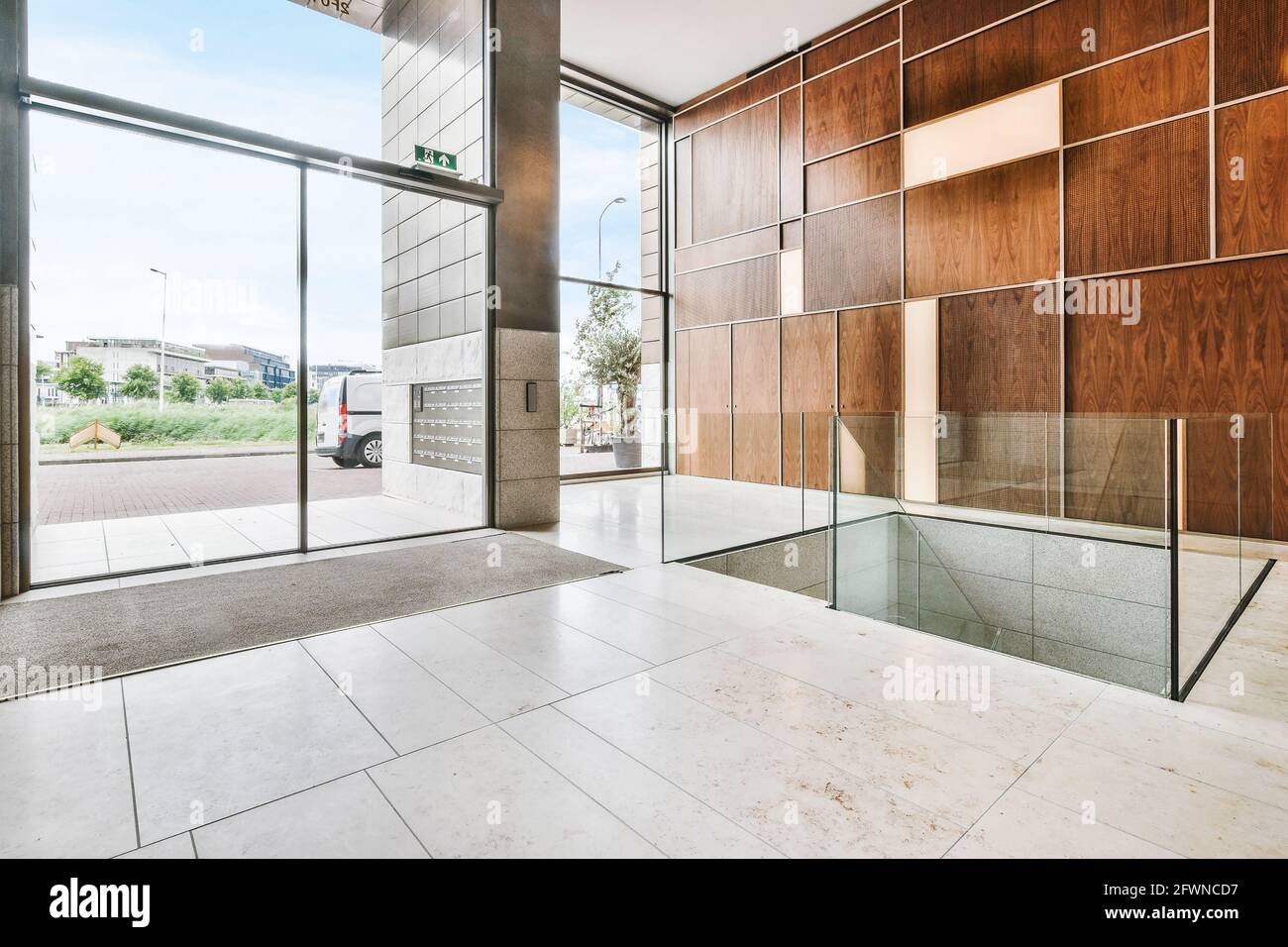 Contemporary interior design of spacious hall with large windows and ...