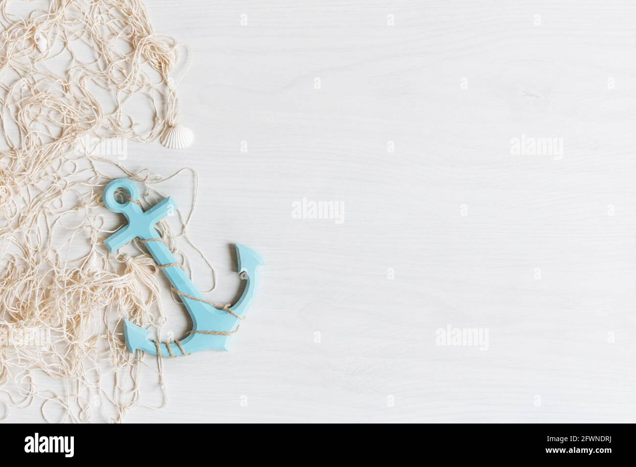 Sea background with fishing net, anchor and seashells top view on white ...