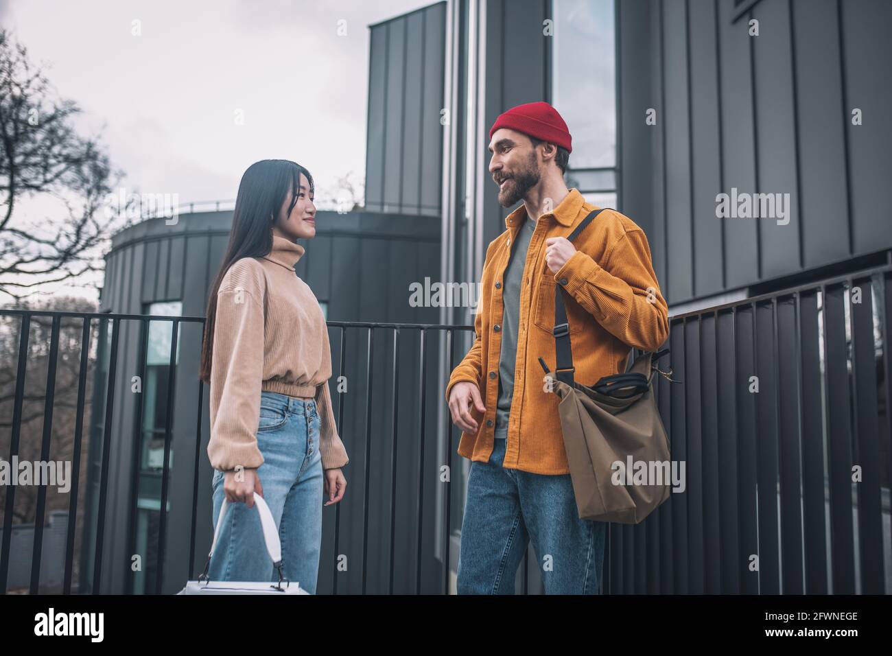 Man and woman talking casual clothes hi-res stock photography and ...