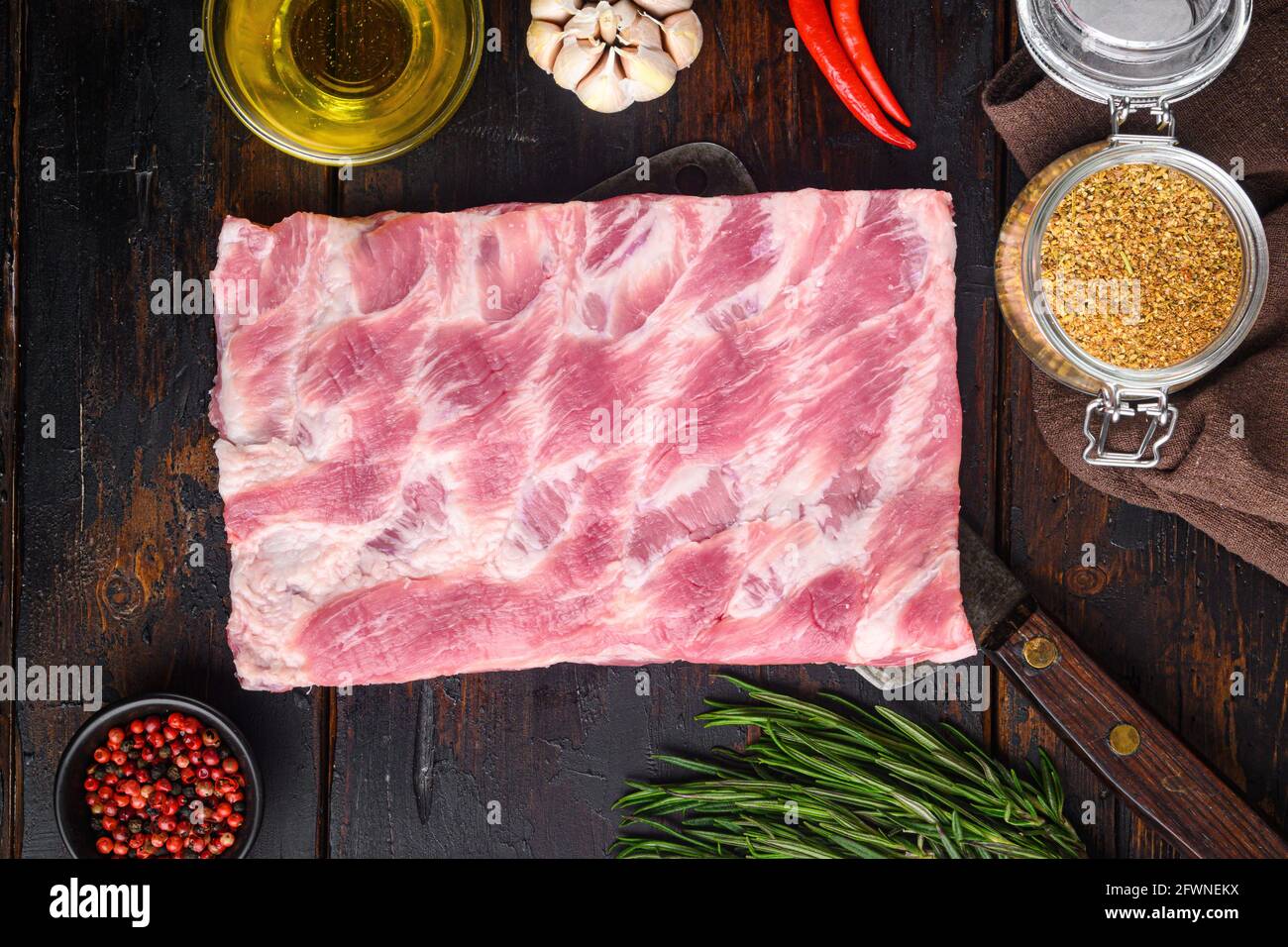 Raw uncooked pork ribs, fresh meat with ingredients set, on old dark ...