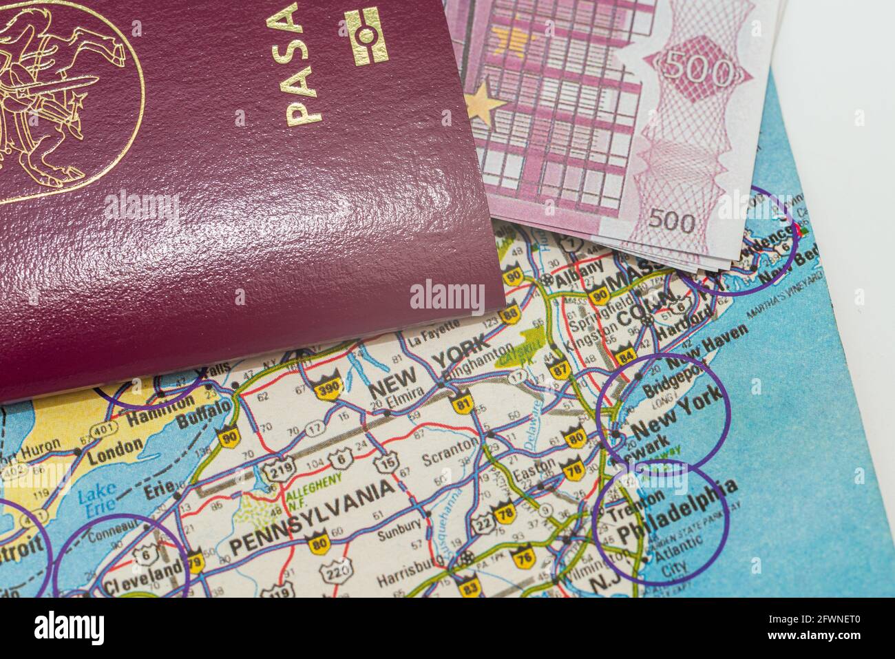 Lithuanian passport 500 euro bills over map. Focus on the New York ...