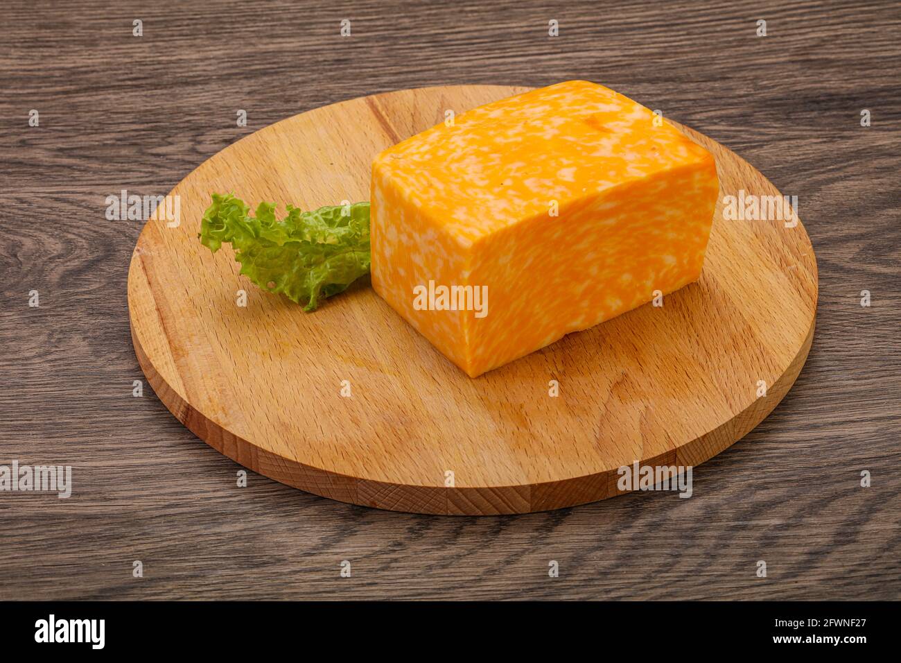 Dairy Marble cheese brick over board Stock Photo - Alamy