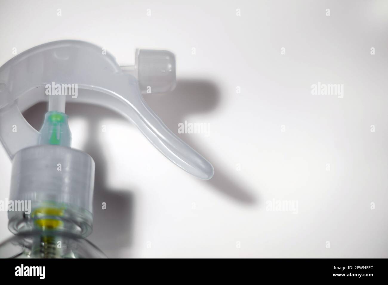 White spray plastic bottle of cleaner antiseptic on white paper ...