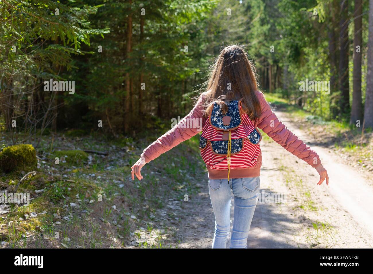 Young traveler girl arms outstretched raised enjoying the fresh air in ...