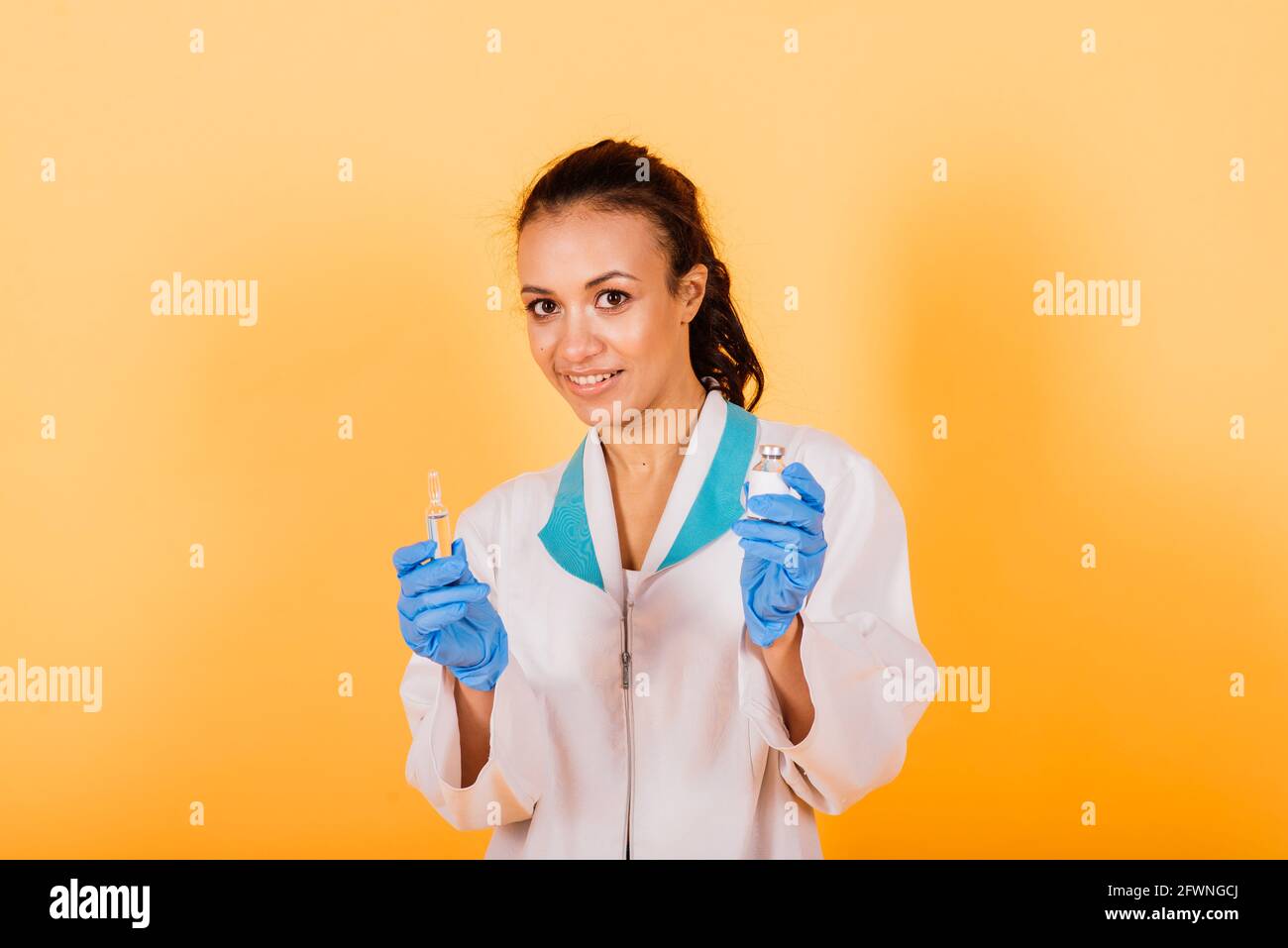 Female medical professional scientist researcher holding a syringe ...