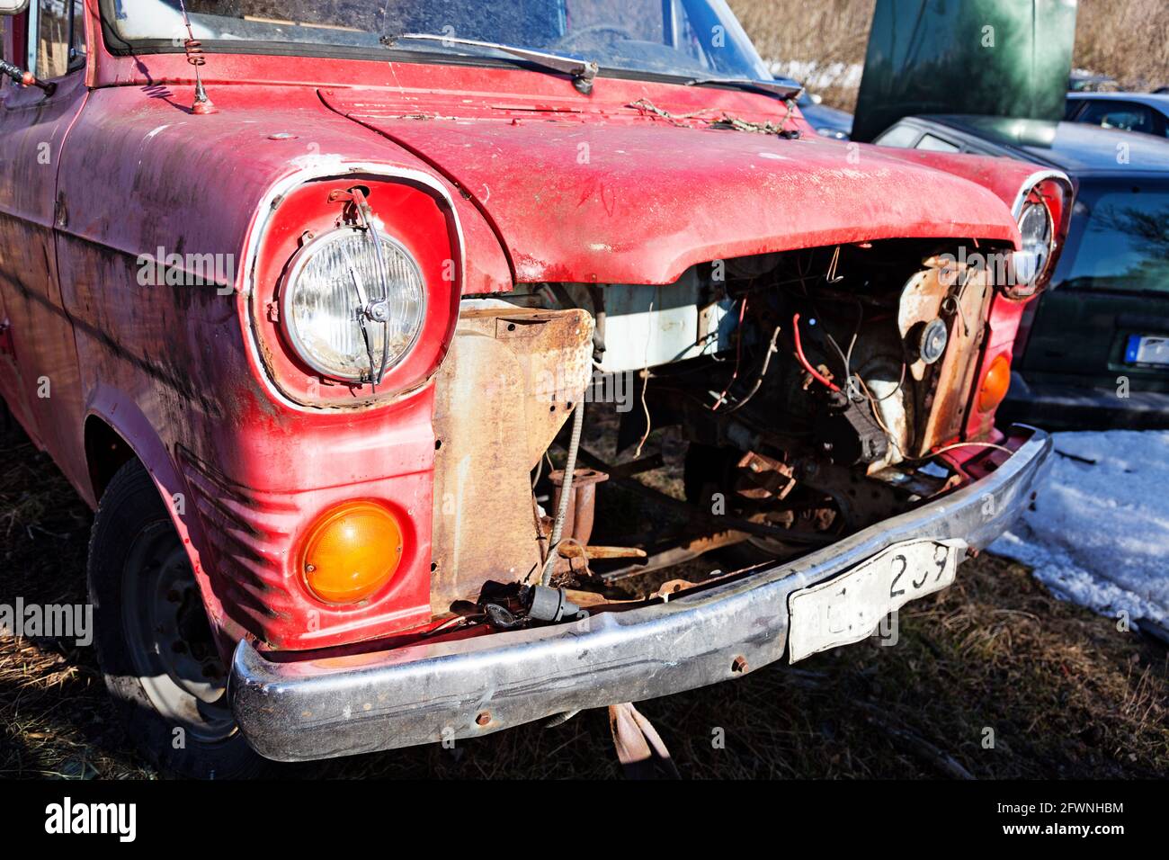 a red scrap car that lacks an engine and more Stock Photo - Alamy