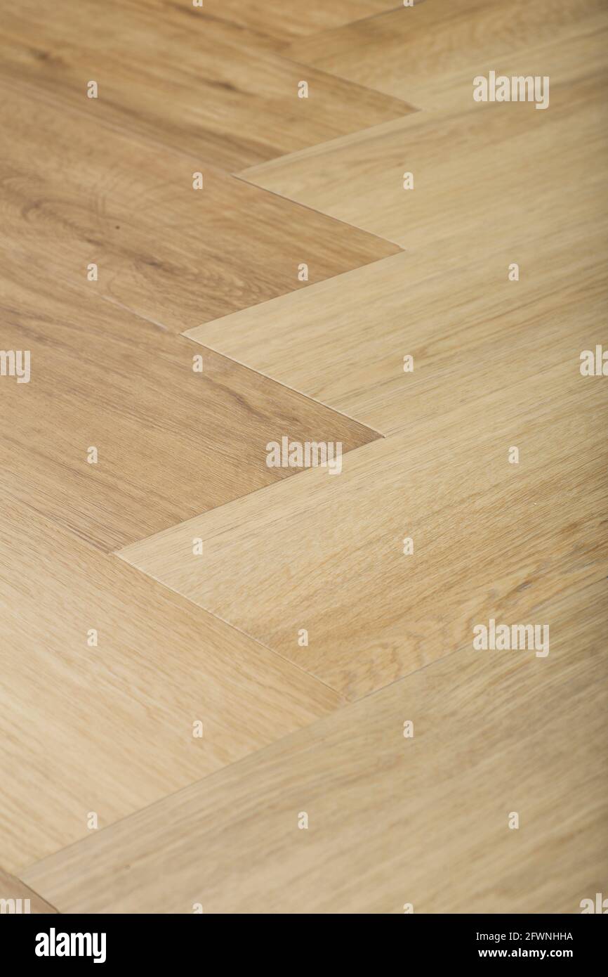 Laminate and parquet with herringbone background. Wooden floor with a ...