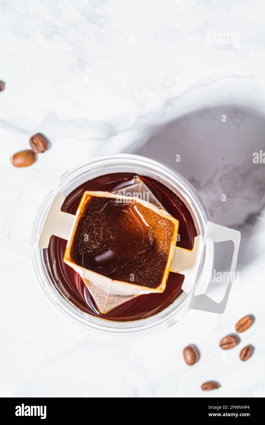 Making coffee with drip coffee bag, top view, copy space. Drip brewing ...