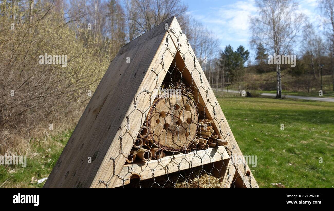 Insect hotel. Wooden structure filled with natural material ready to ...