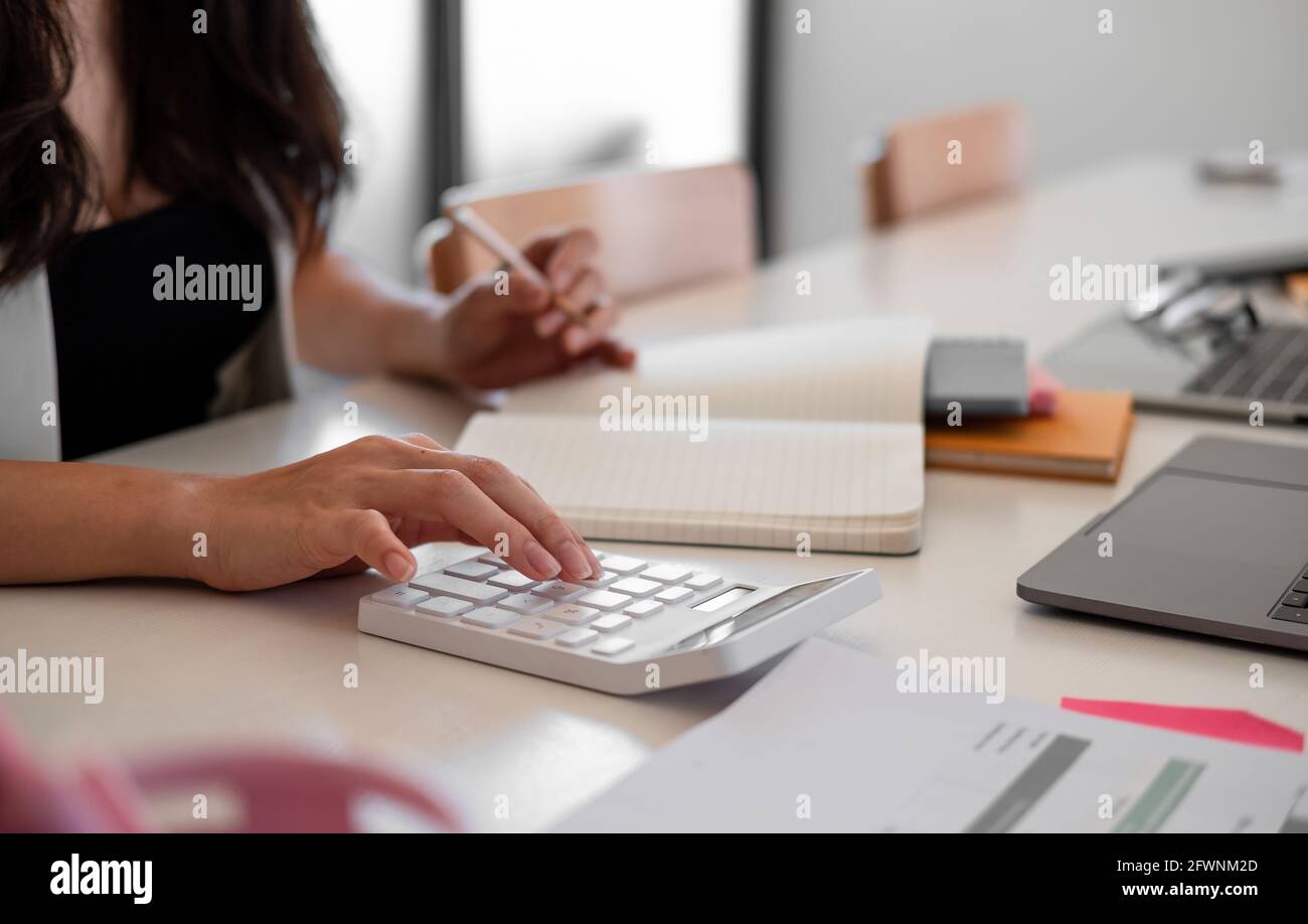 Business woman with calculator counting making notes at office hand is ...