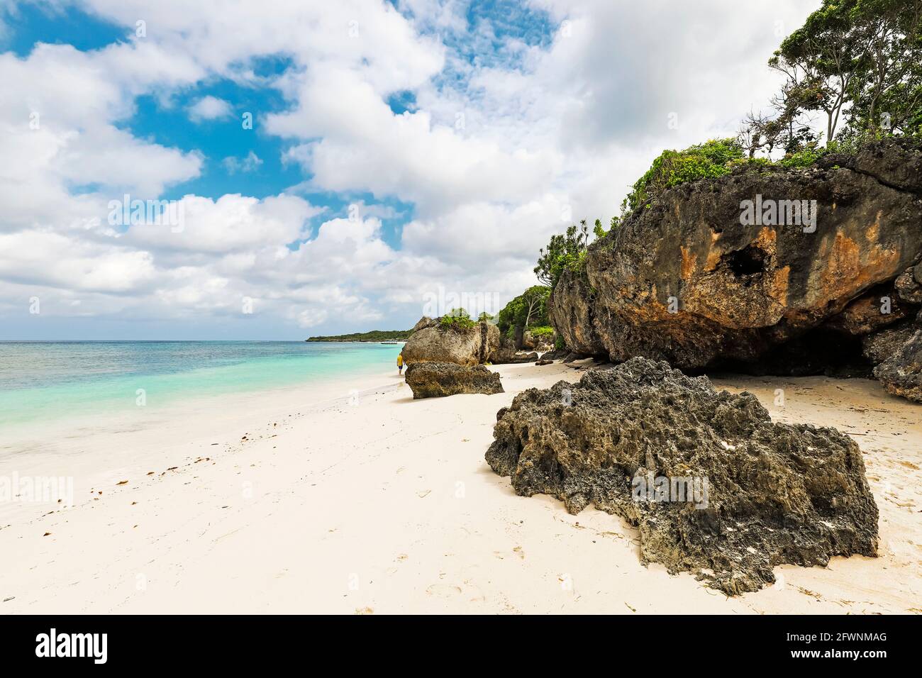 Eroded limestone cliffs by the beautiful white sand Bira beach near ...
