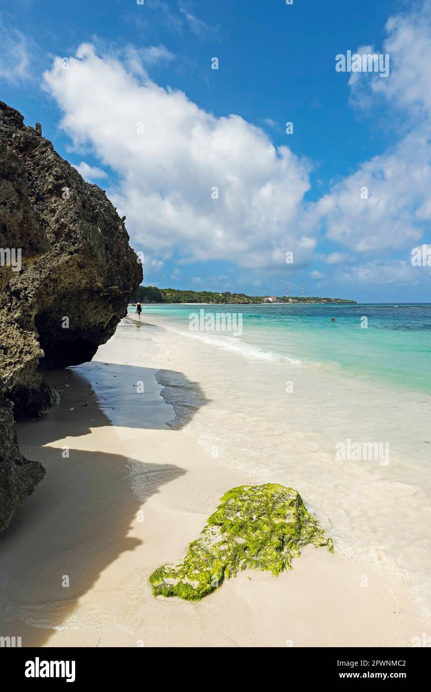 Eroded limestone cliffs by the beautiful white sand Bira beach near ...