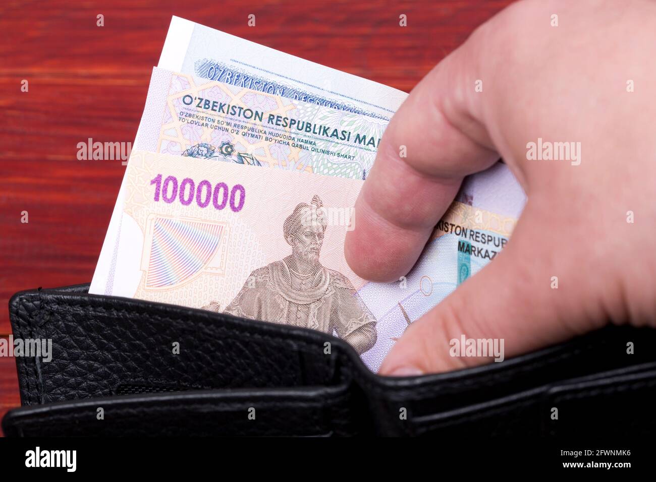 Uzbekistani money - som in the wallet Stock Photo - Alamy