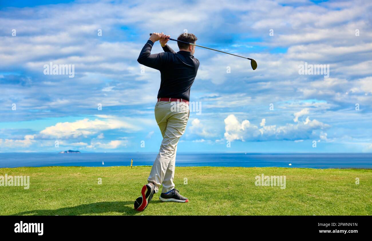 Golfer on the professional golf course. Golfer with golf club hitting ...