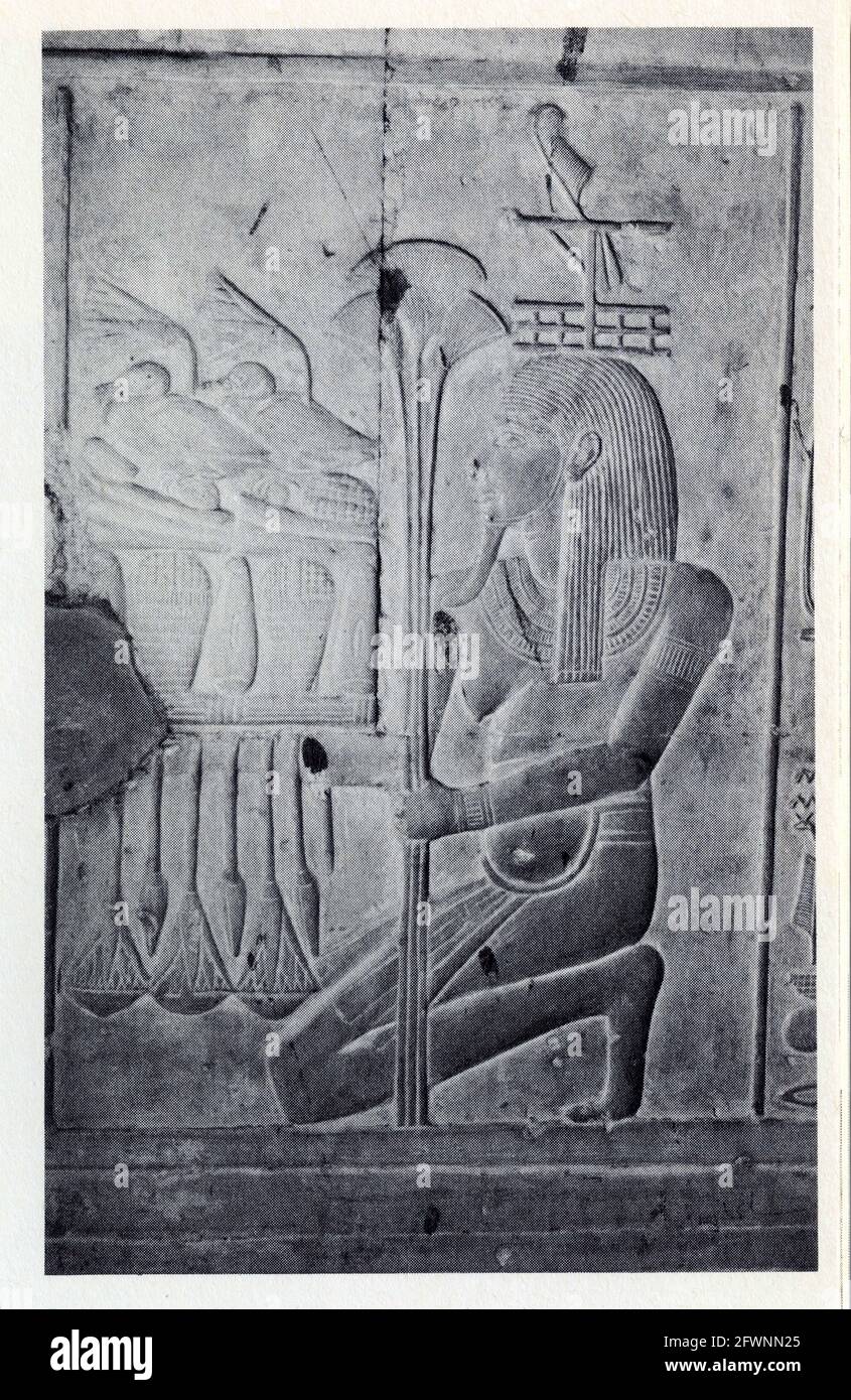 Relief of the Nile god Hapi shown kneeling holding an offering table ...