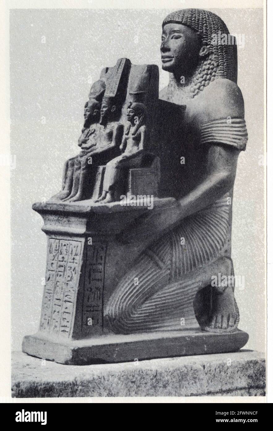 Ramesses-Nakht,High Priest of Amun,kneels to present a small shrine ...